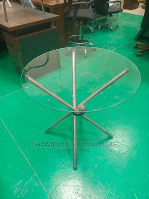 Round Clear Glass Table With Cris Crossing Metallic Stand in Imara ...